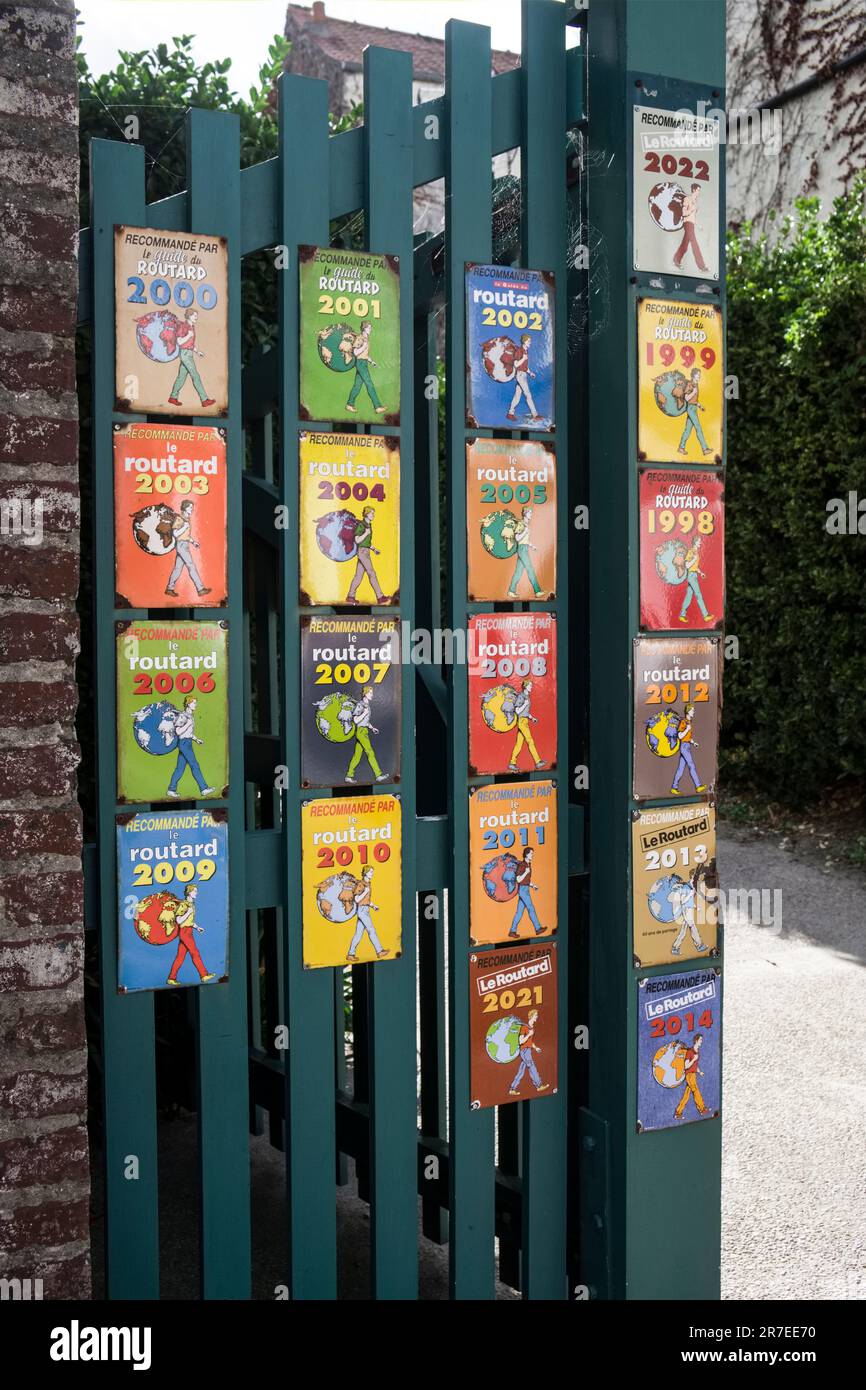 Plaques of the “Guide du Routard” tourist guide in front of a ...