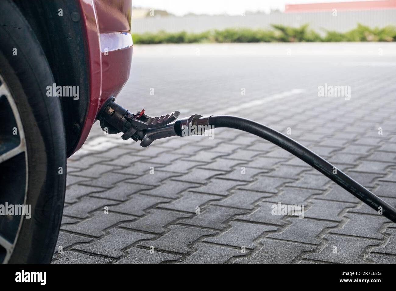 Filling a gas filling gun in a gas-powered car at a gas station during ...