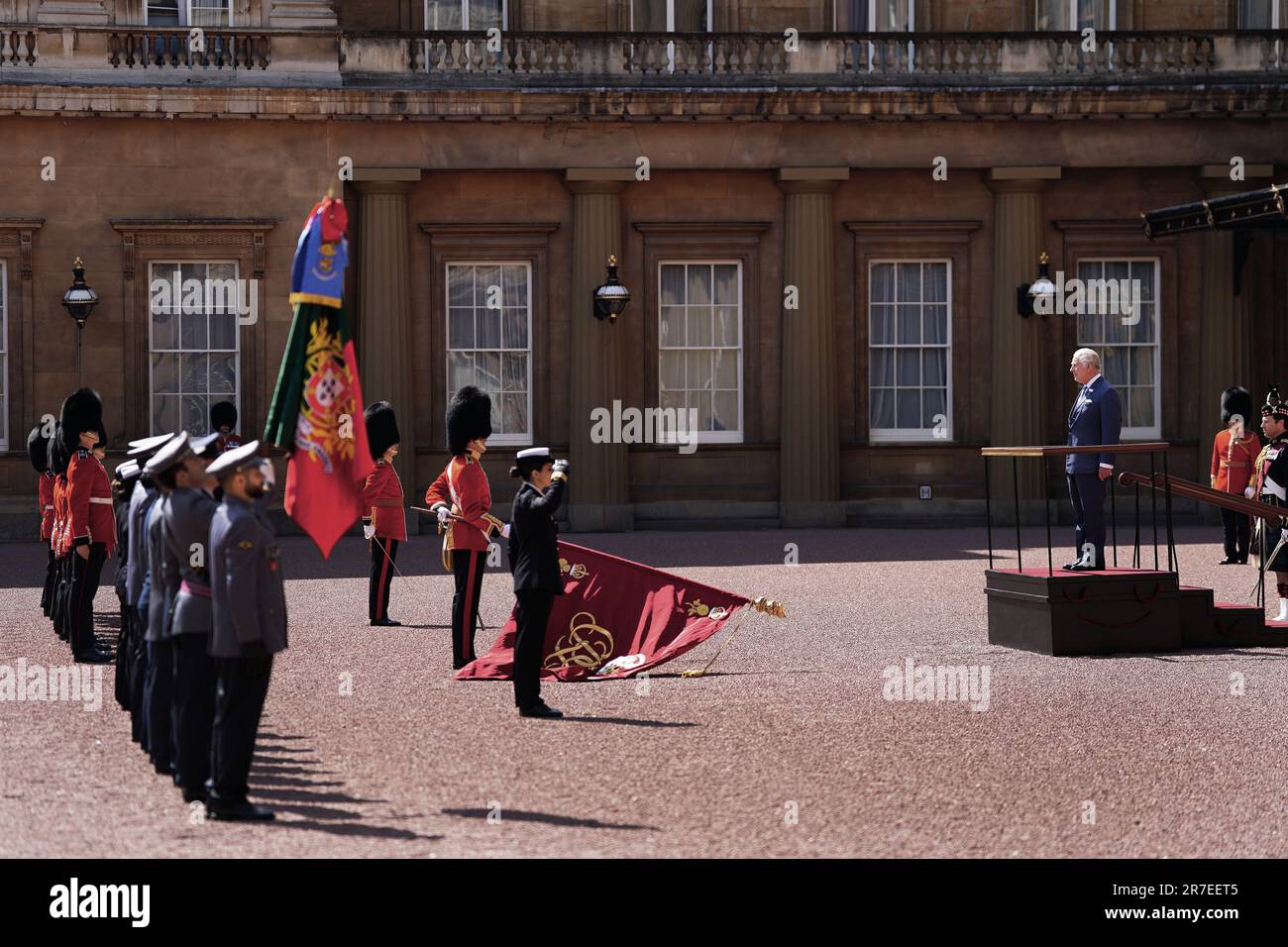 King Charles III, stands on a dais as he takes a royal salute on the ...