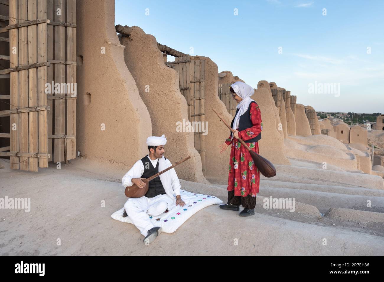 A couple play traditional music instrument and play the folkur dance in ...