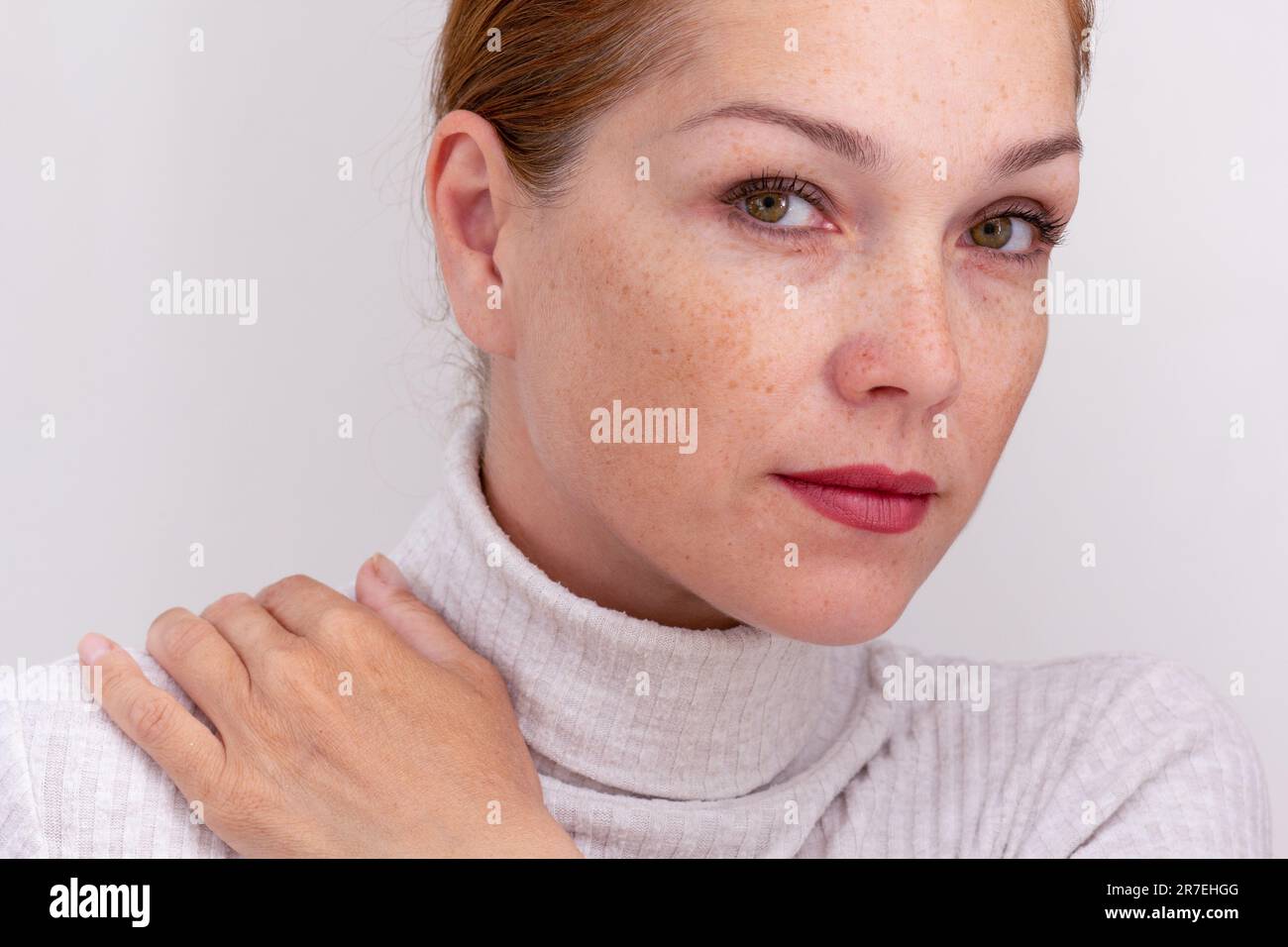Portrait of cropped caucasian middle aged woman face with freckles on ...