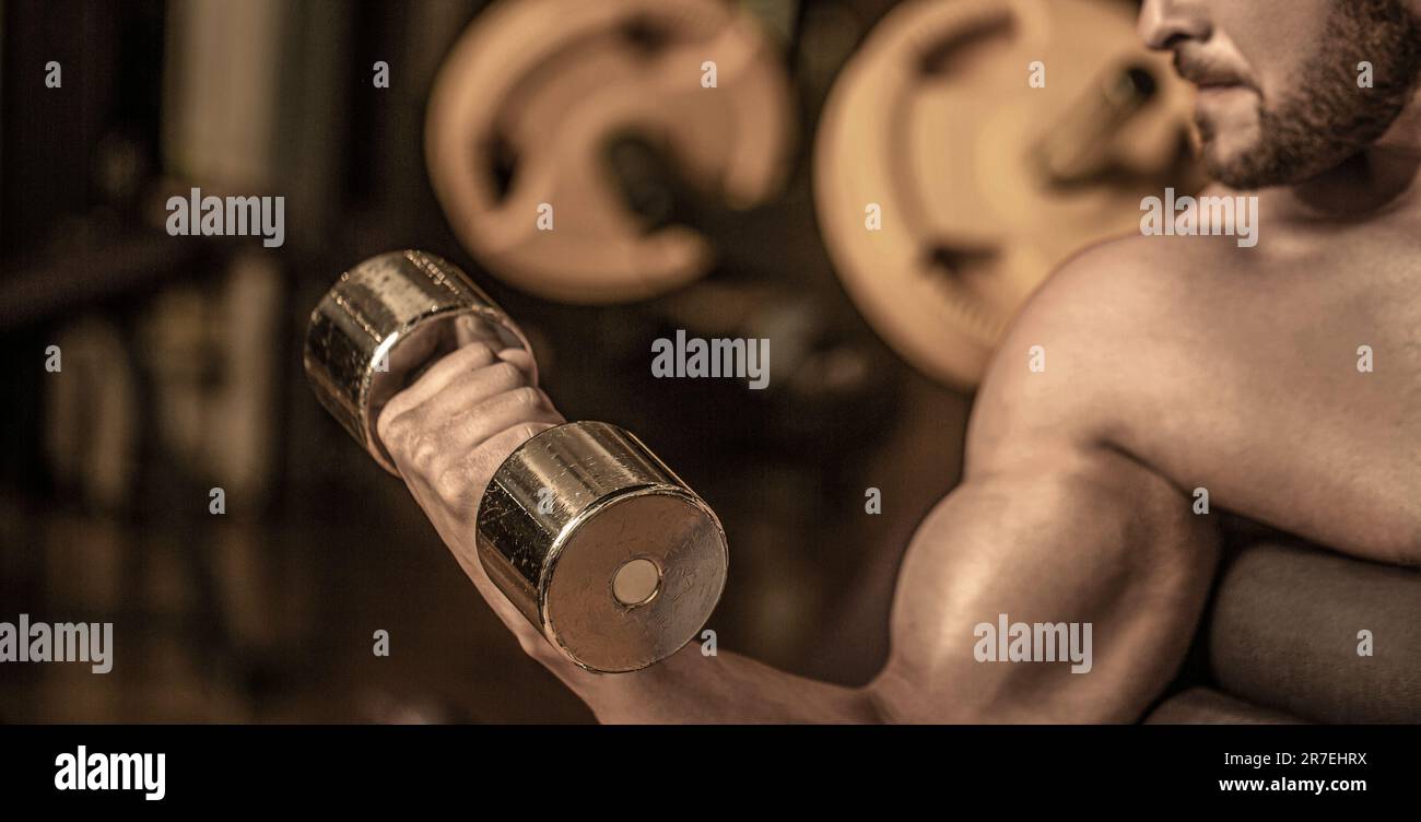 Man lifting dumbbell in a gym making exercise for muscles. Man ...
