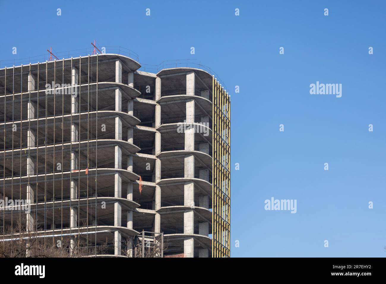 The subject of the photo is the construction of a building of a ...