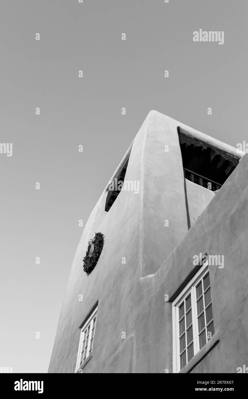 An angular building with two windows near the apex, illuminated by ...