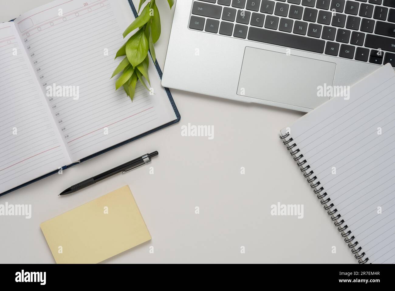 Modern white office desk table with laptop, notebook and other supplies ...