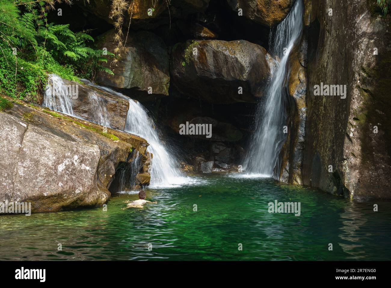Swimming towards a secret cave behind an emerald waterfall Stock Photo ...