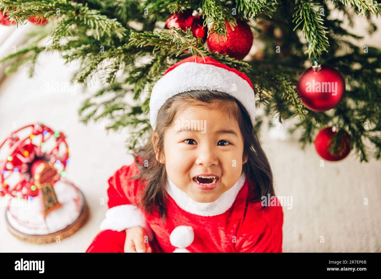 Christmas portrait of adorable 3 year old asian toddler girl wearing ...