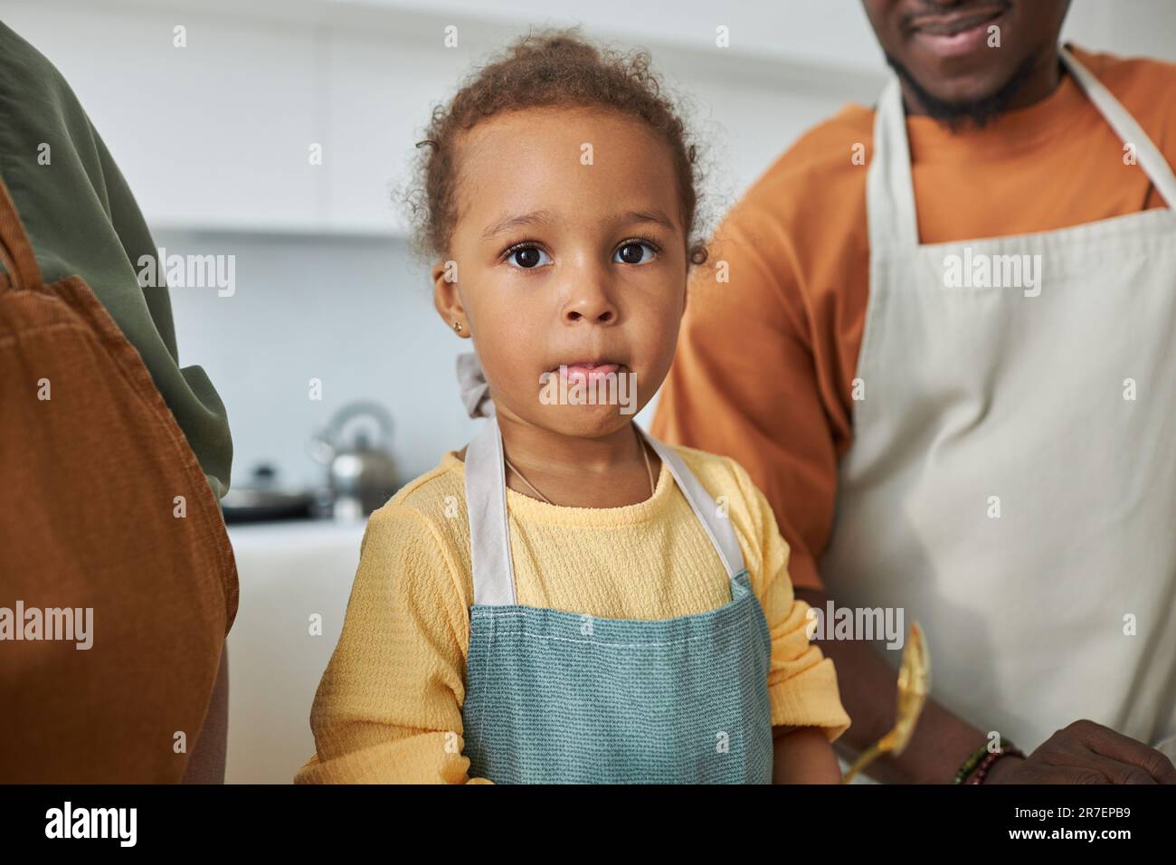 Portrait of African American little girl cooking in the kitchen ...