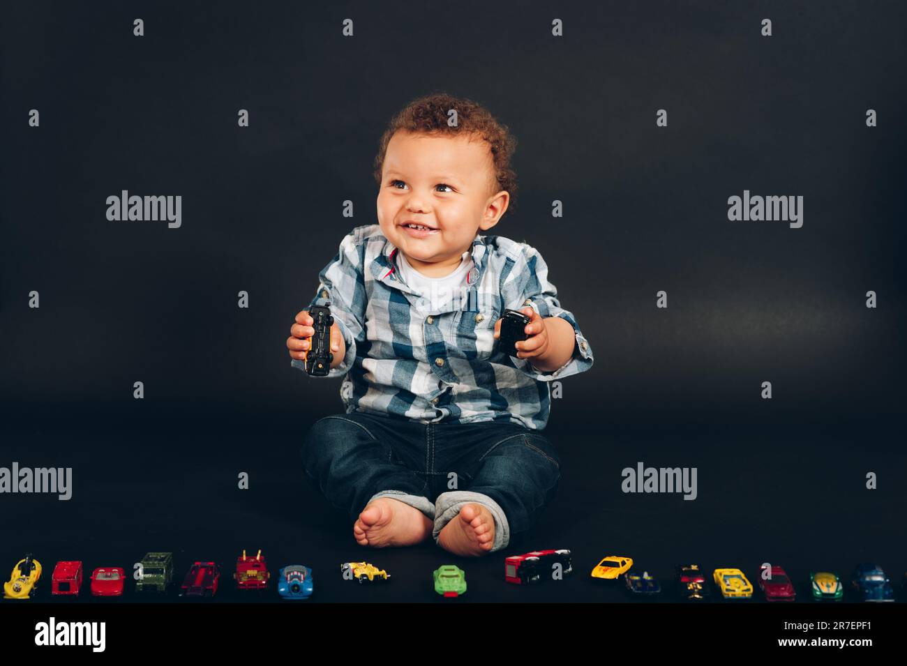 Studio shot of adorable african 9-12 month old baby boy playing with ...