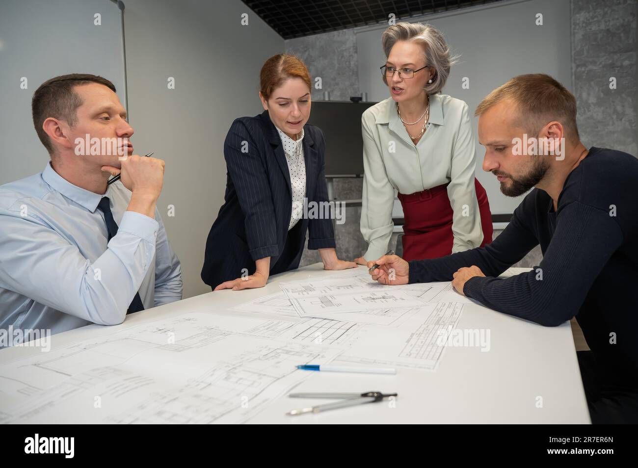 Engineers discuss project blueprints hi-res stock photography and ...