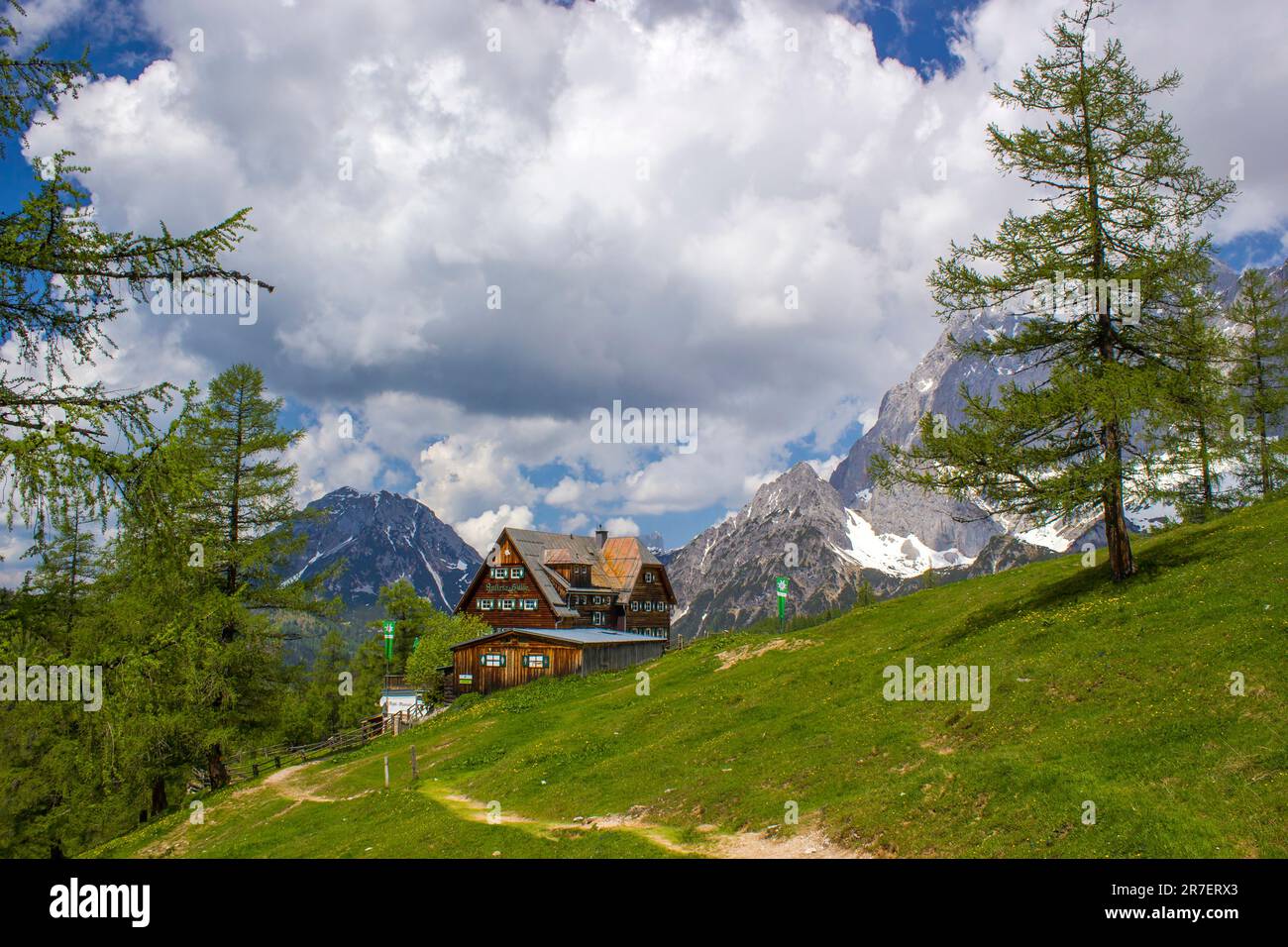 Panorama of massive Alpine mountains. Landscape with mountain hut in ...
