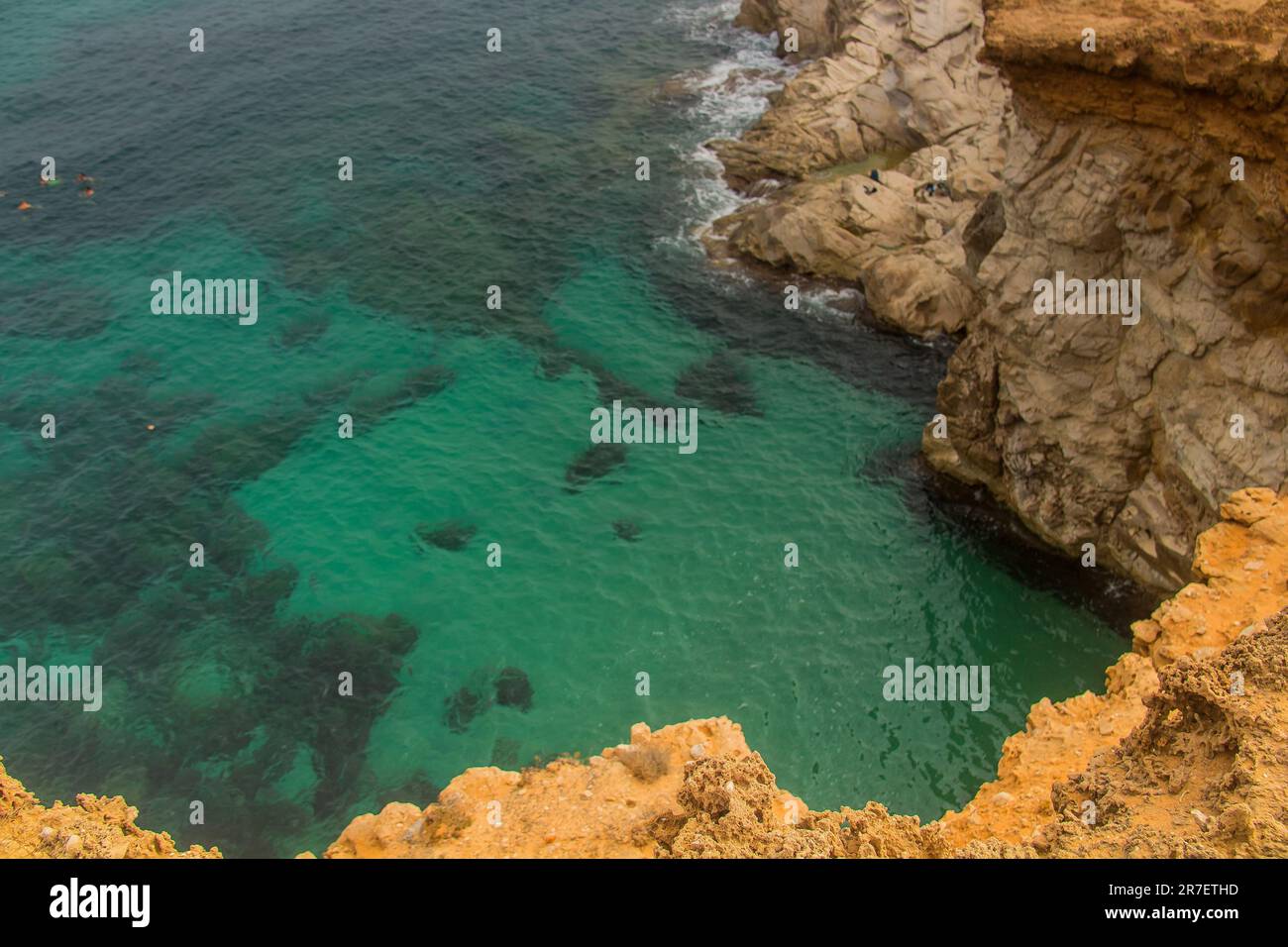 Rock-Studded Beach Beneath a Cliff in Tunisia. North Africa Stock Photo ...