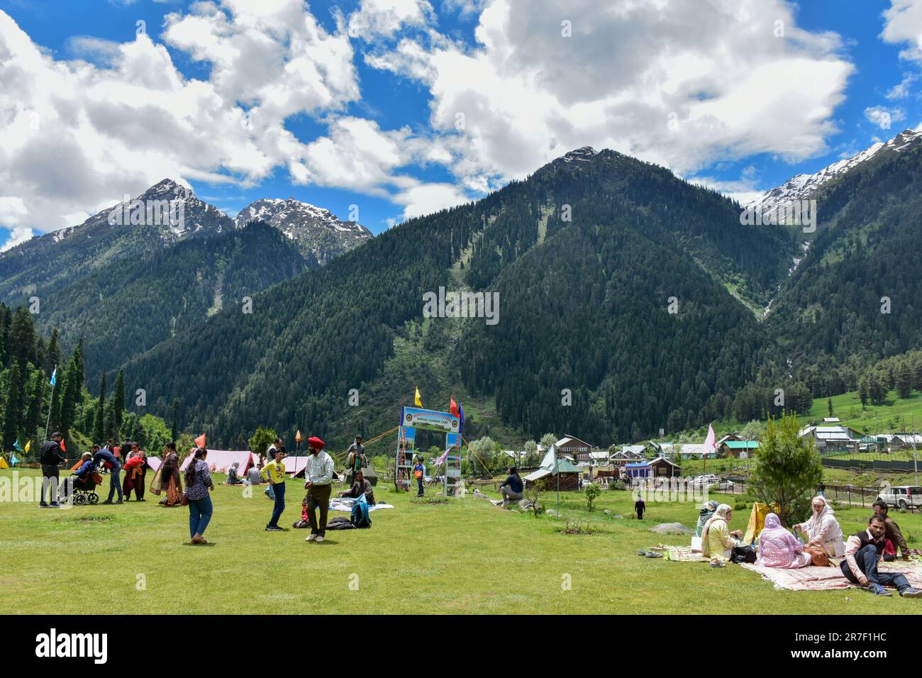 Pahalgam, India. 15th June, 2023. Indian tourists and locals rest in a ...