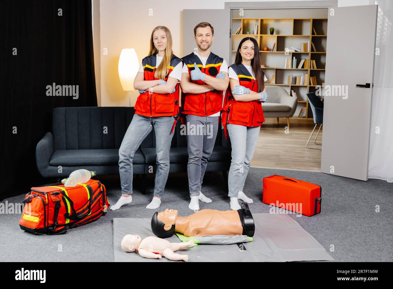 Group of people with cpr dummy looking at camera and smiling after ...
