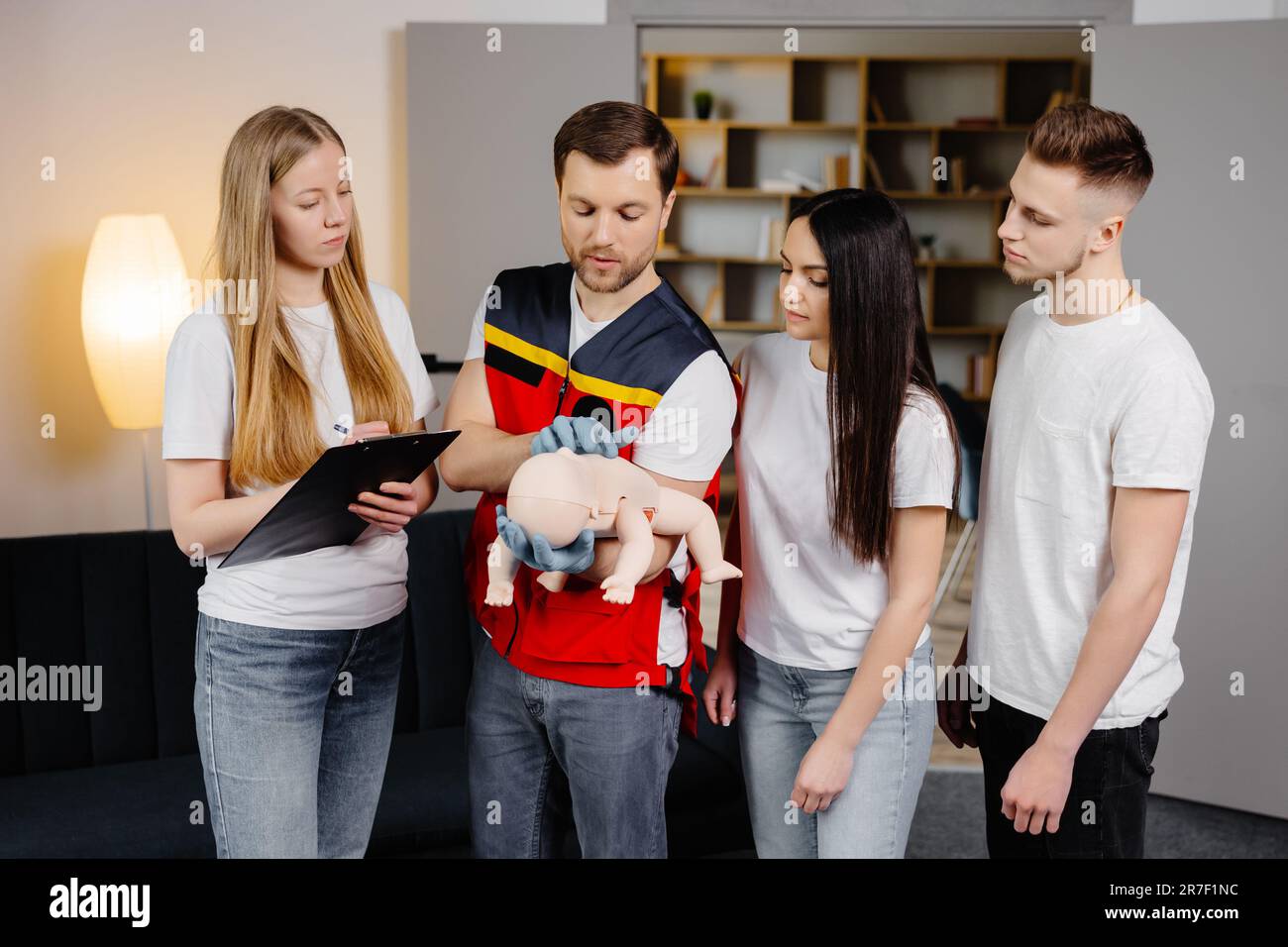Group of people learning how to make first aid with dummy child during ...