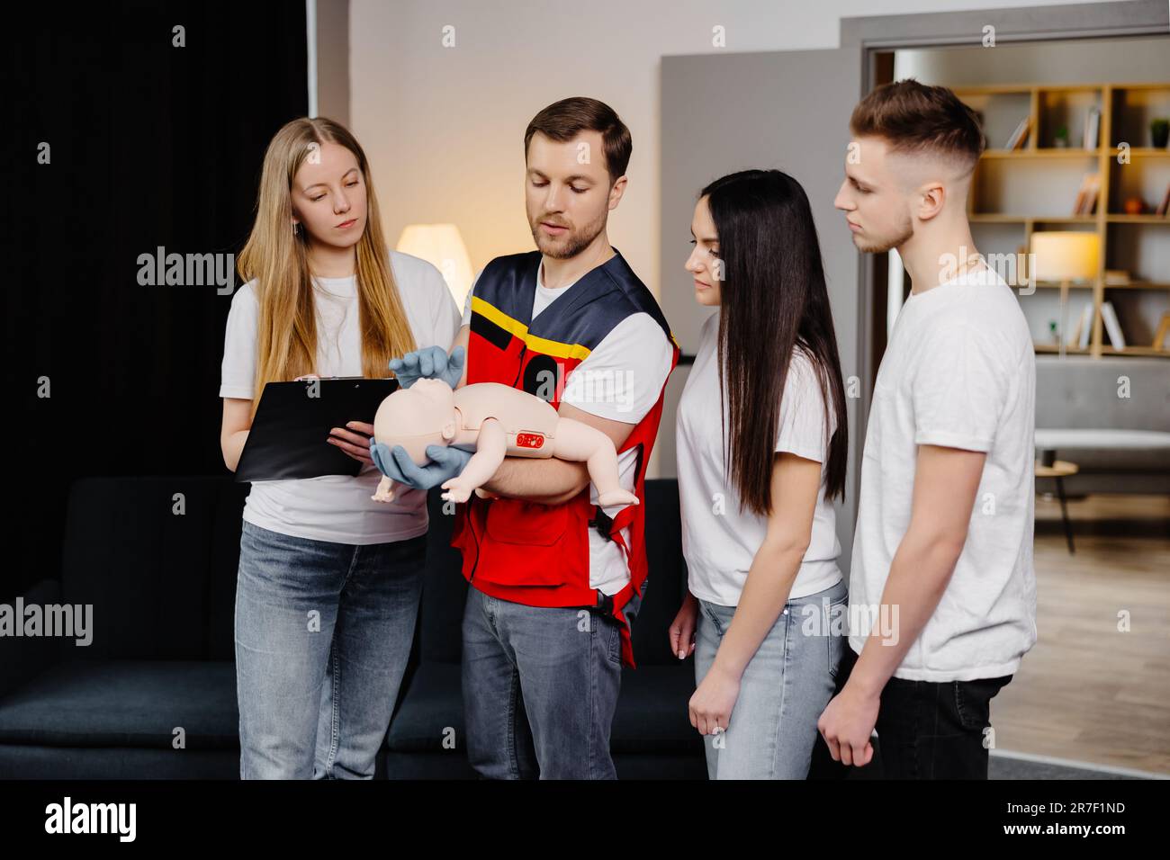 Group of people learning how to make first aid with dummy child during ...