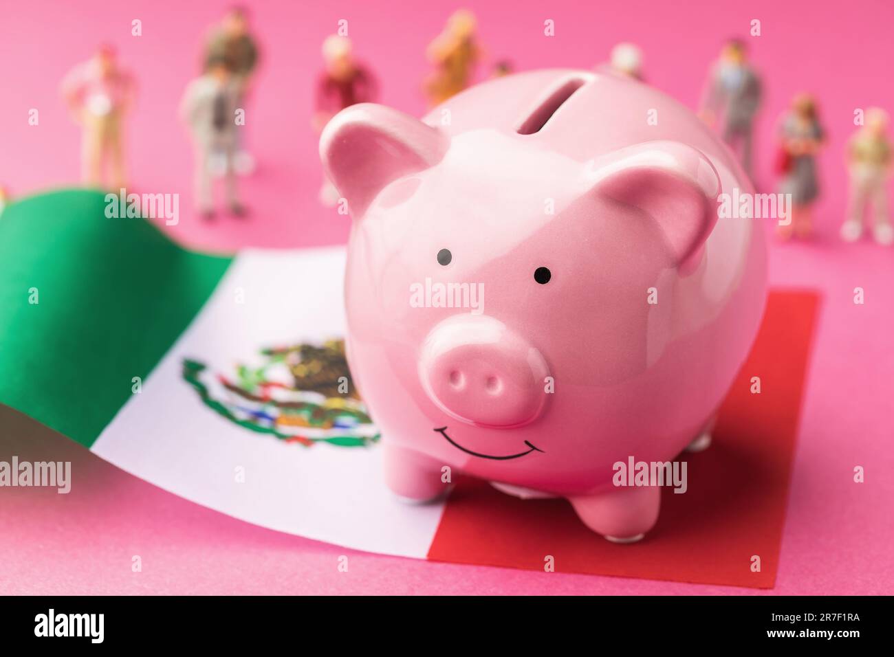 Piggy bank, Mexican flag and plastic toy men on a colored background, a ...