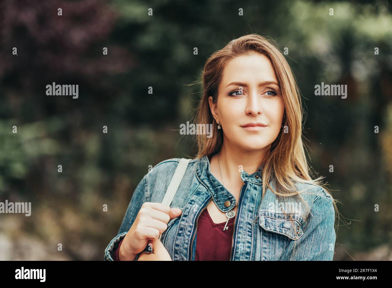 Outdoor portrait of young woman wearing denim jacket Stock Photo - Alamy
