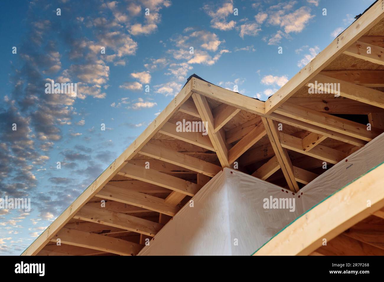 Corner of a house with eaves beams planks wooden rafters is under ...