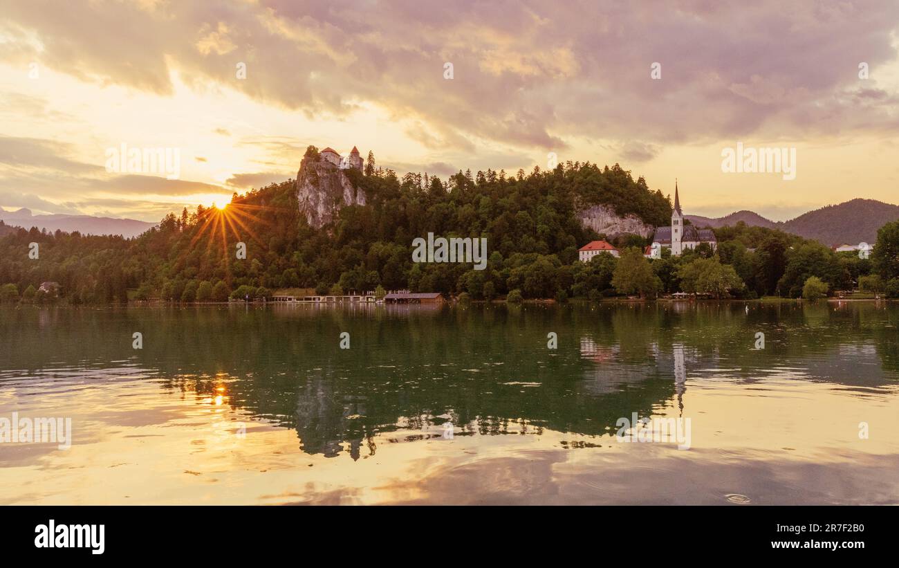 sunburst effect as the sun sets behind bled castle makes a beautiful ...