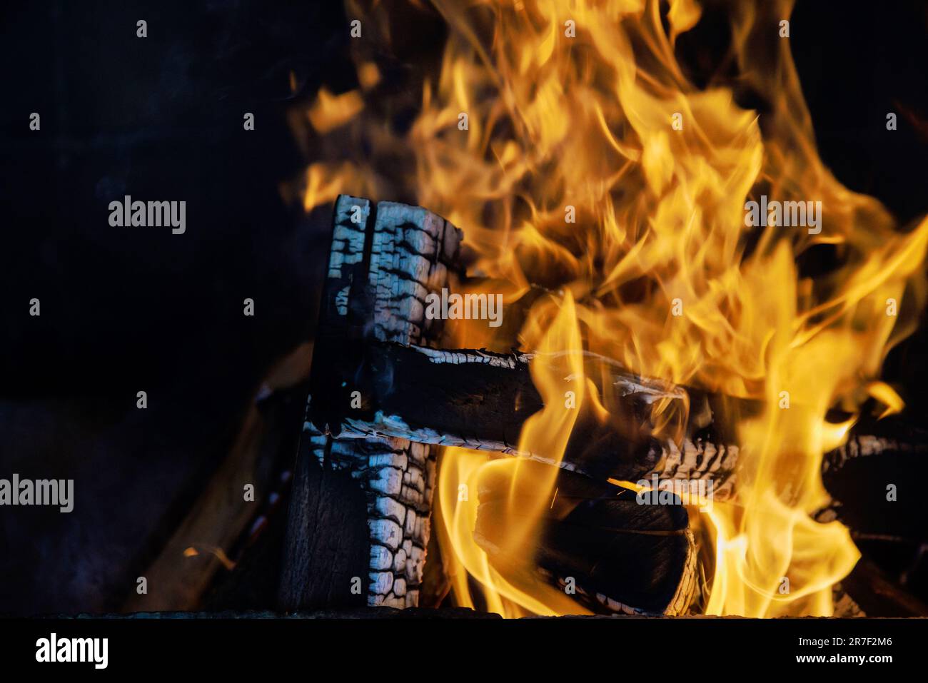 In winter months flickering flames of wood fire in traditional rural ...