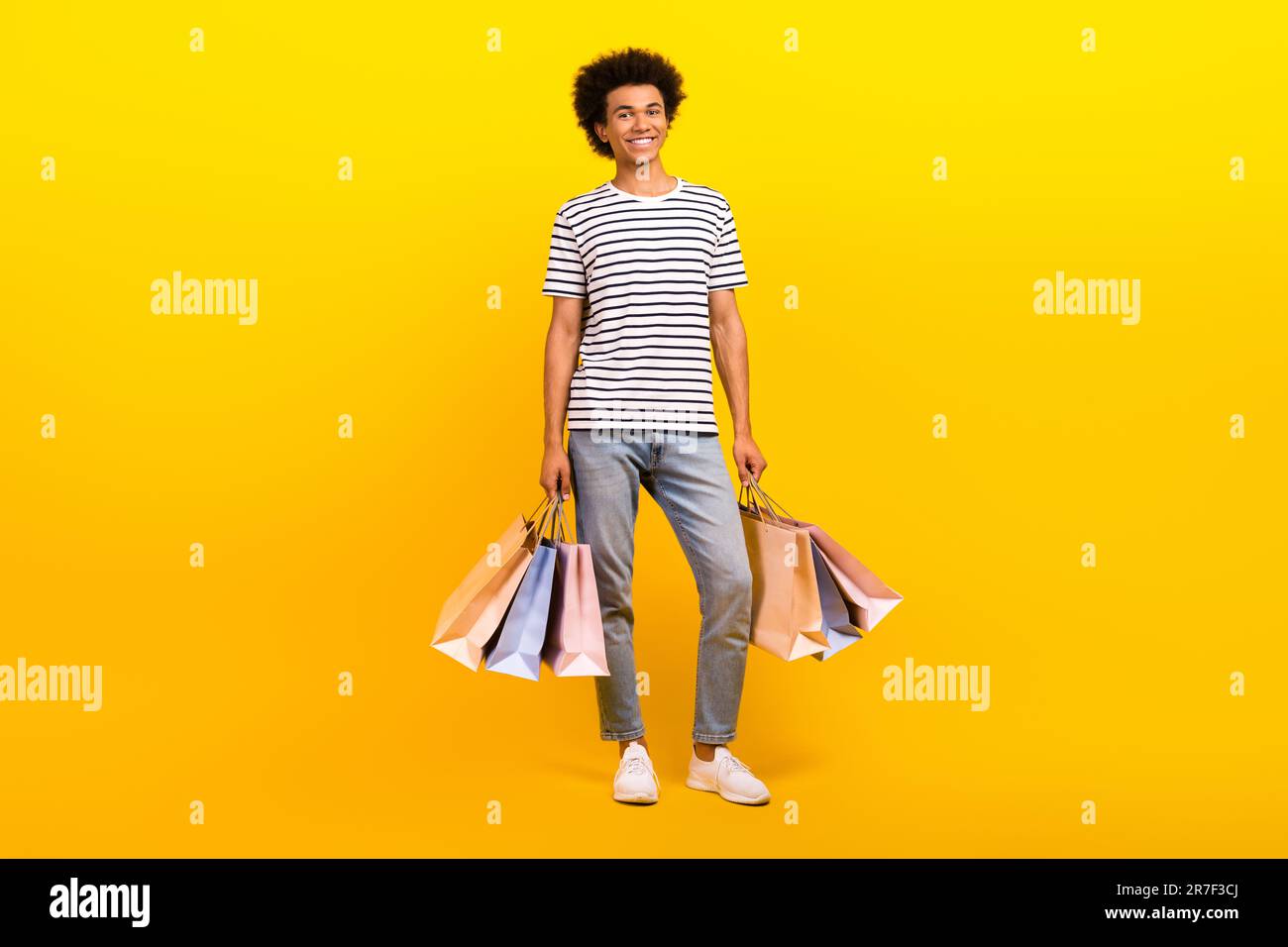 Full body cadre of young man funny chevelure wear striped t-shirt hold ...