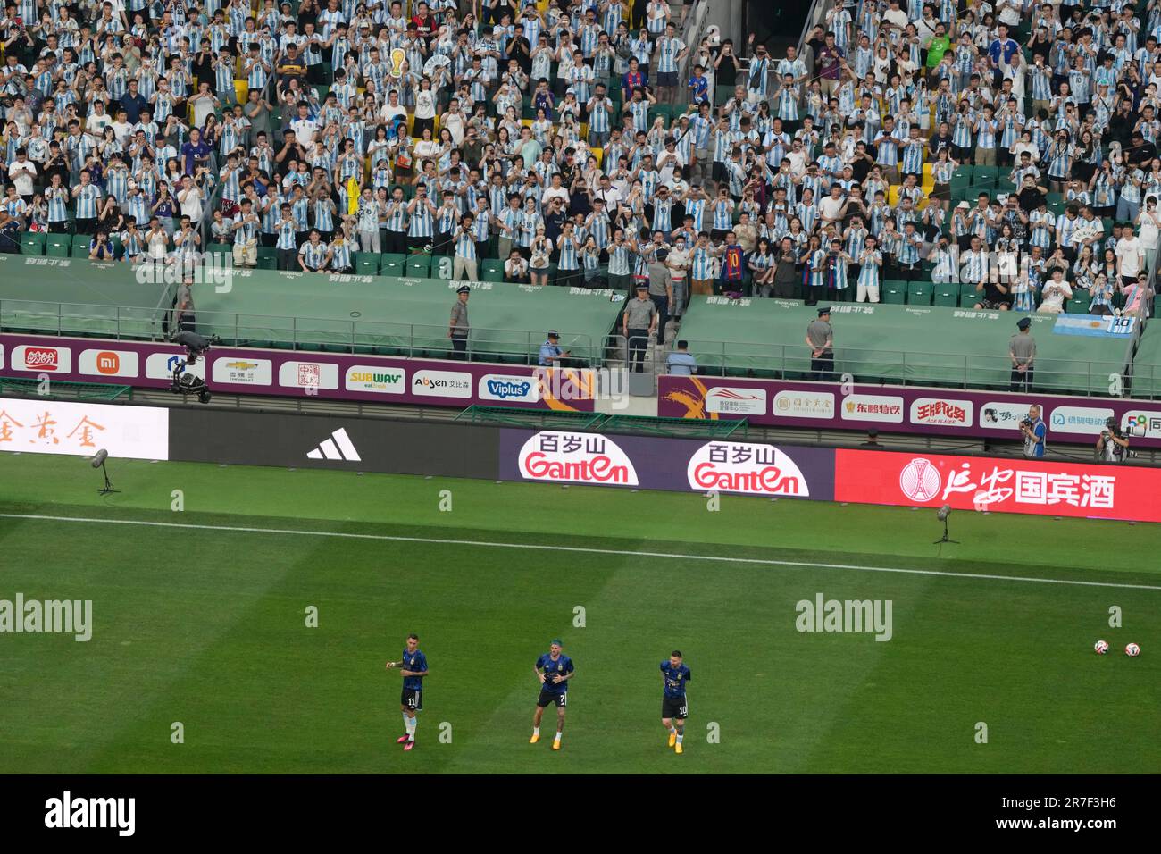 Chinese fans cheer as Argentina's Lionel Messi, bottom right, gets ...