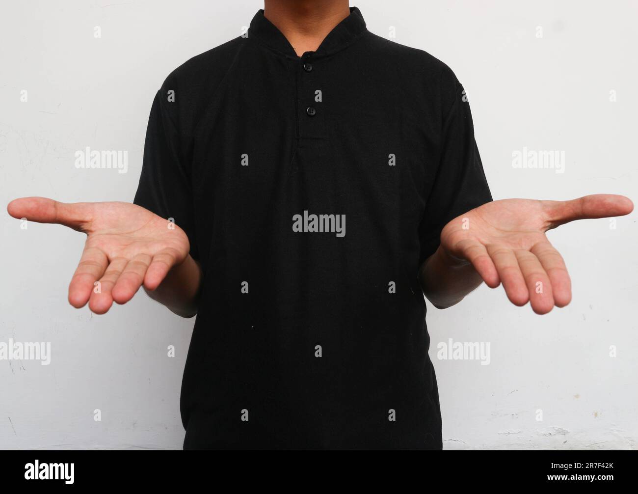 The man with black shirt open wide hands in gesture to invite to ...