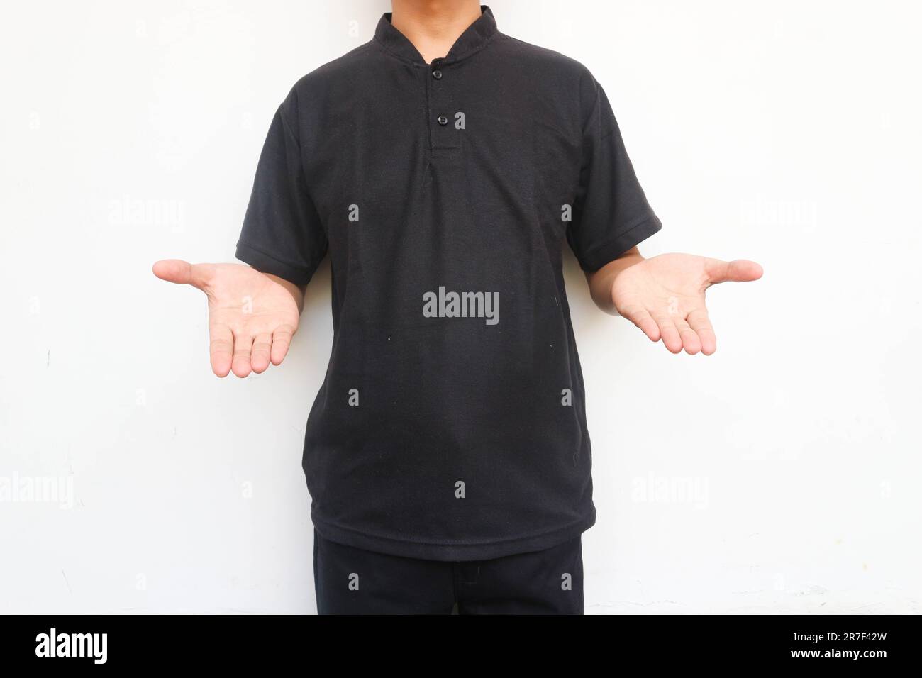 The man with black shirt open wide hands in gesture to invite to ...