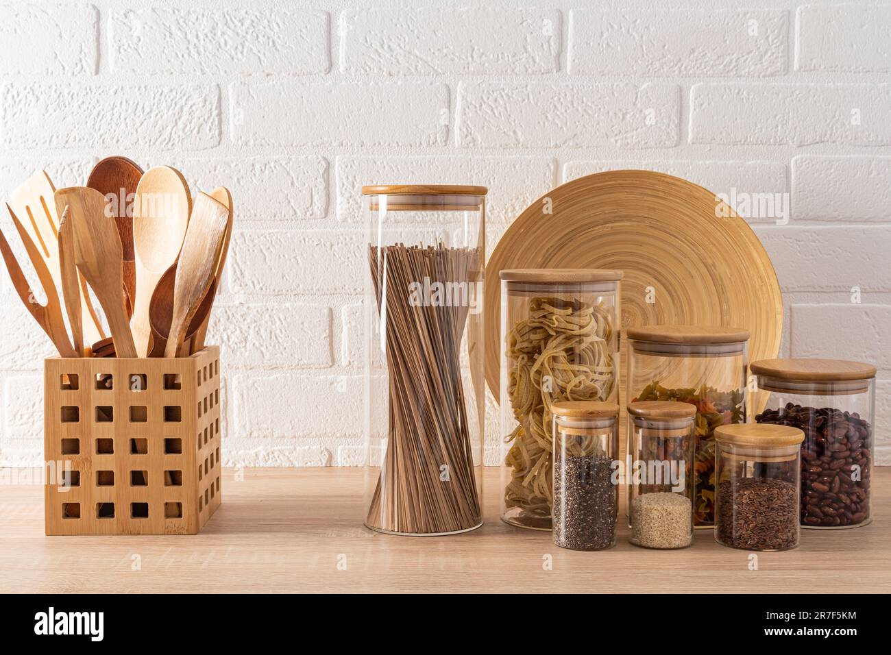 A set of glass jars with various bulk products and spices on the ...