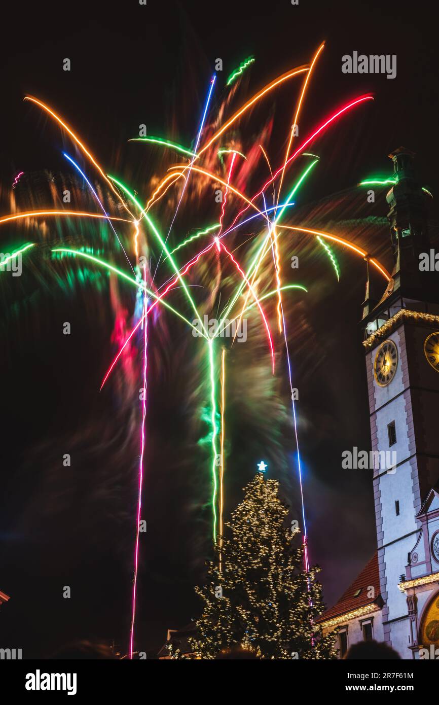 An illuminated night sky displaying a vibrant fireworks show over a ...