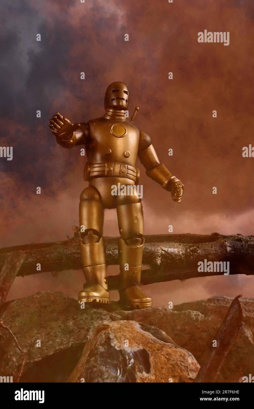 Iron Man original gold armour action figure on rocky cloudy background ...