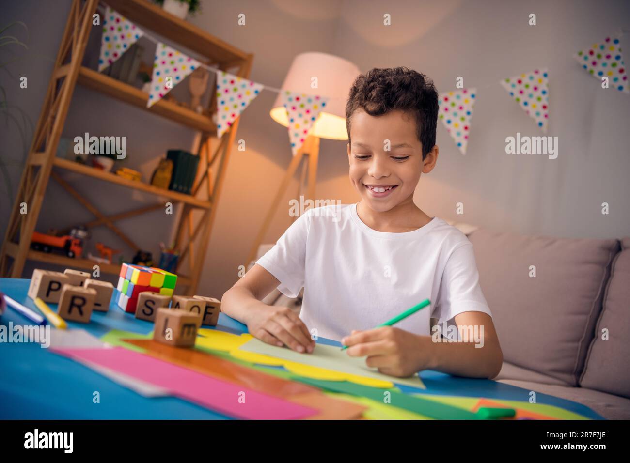 Portrait of nice cheerful cute little boy drawing doing homework smile ...