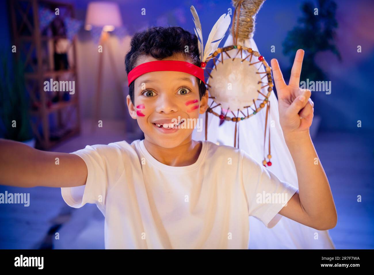 Photo of positive funny cute boy playing game native indians with ...