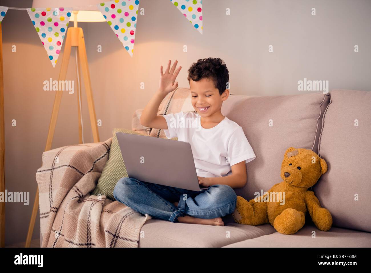 Photo of cute boy school kid connected to online lesson answer teacher ...