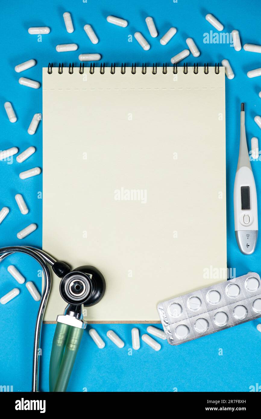 Medical mockup - notepad with stethoscope, pills and thermometer, top ...