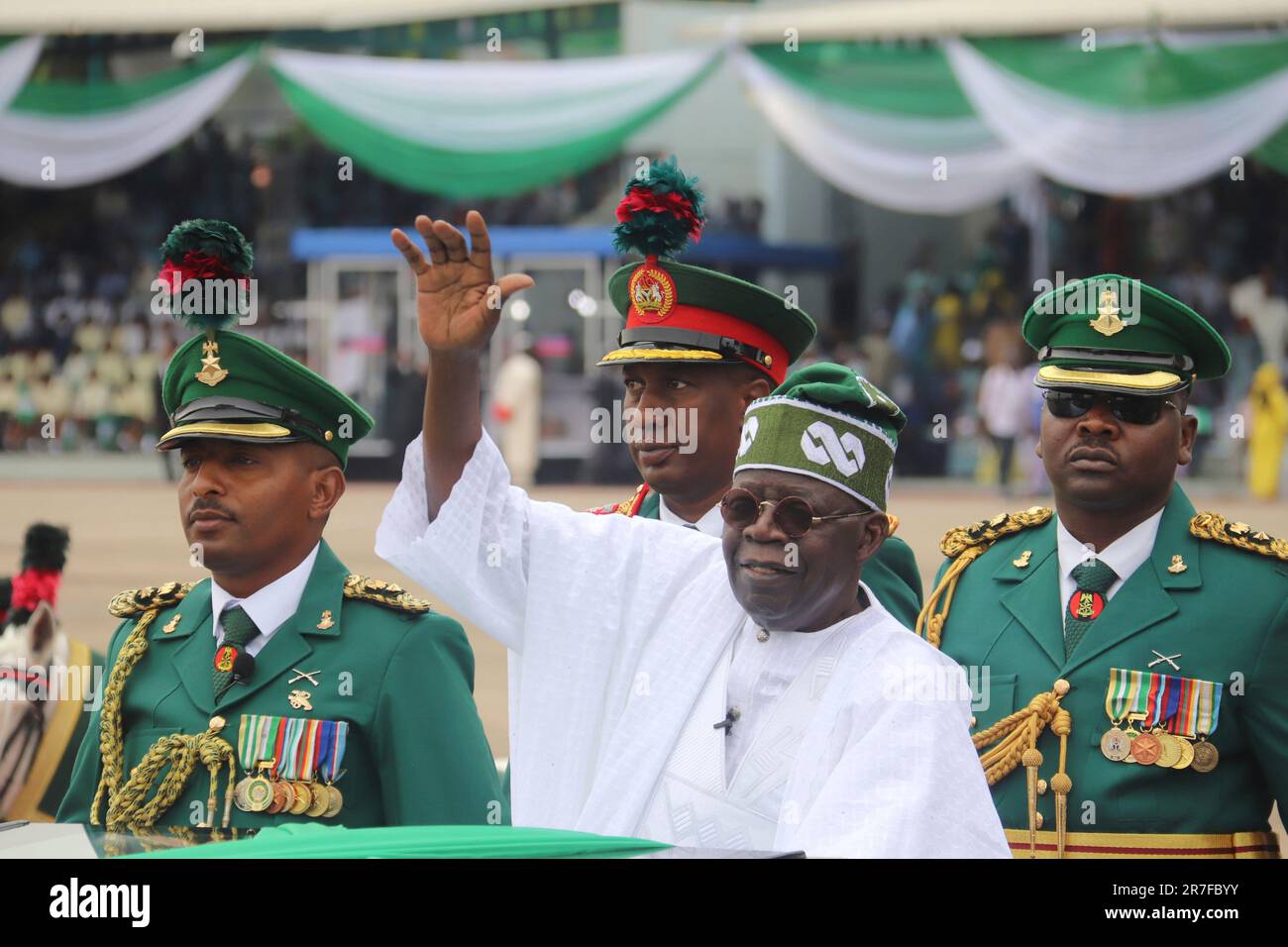 FILE- Nigeria's new President Bola Ahmed Tinubu inspects honour guards after taking an oath of ...