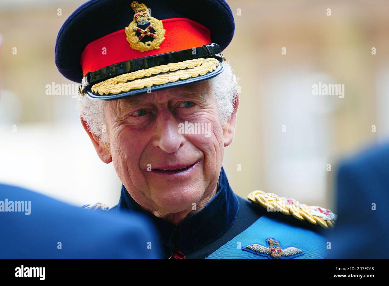 Britain's King Charles III speaks with guests as he and Britain's ...