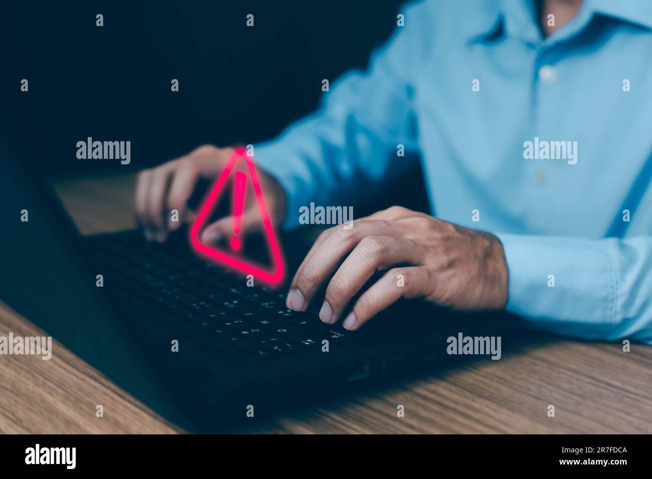 Businessman using computer laptop with triangle caution warning sing for notification error and ...