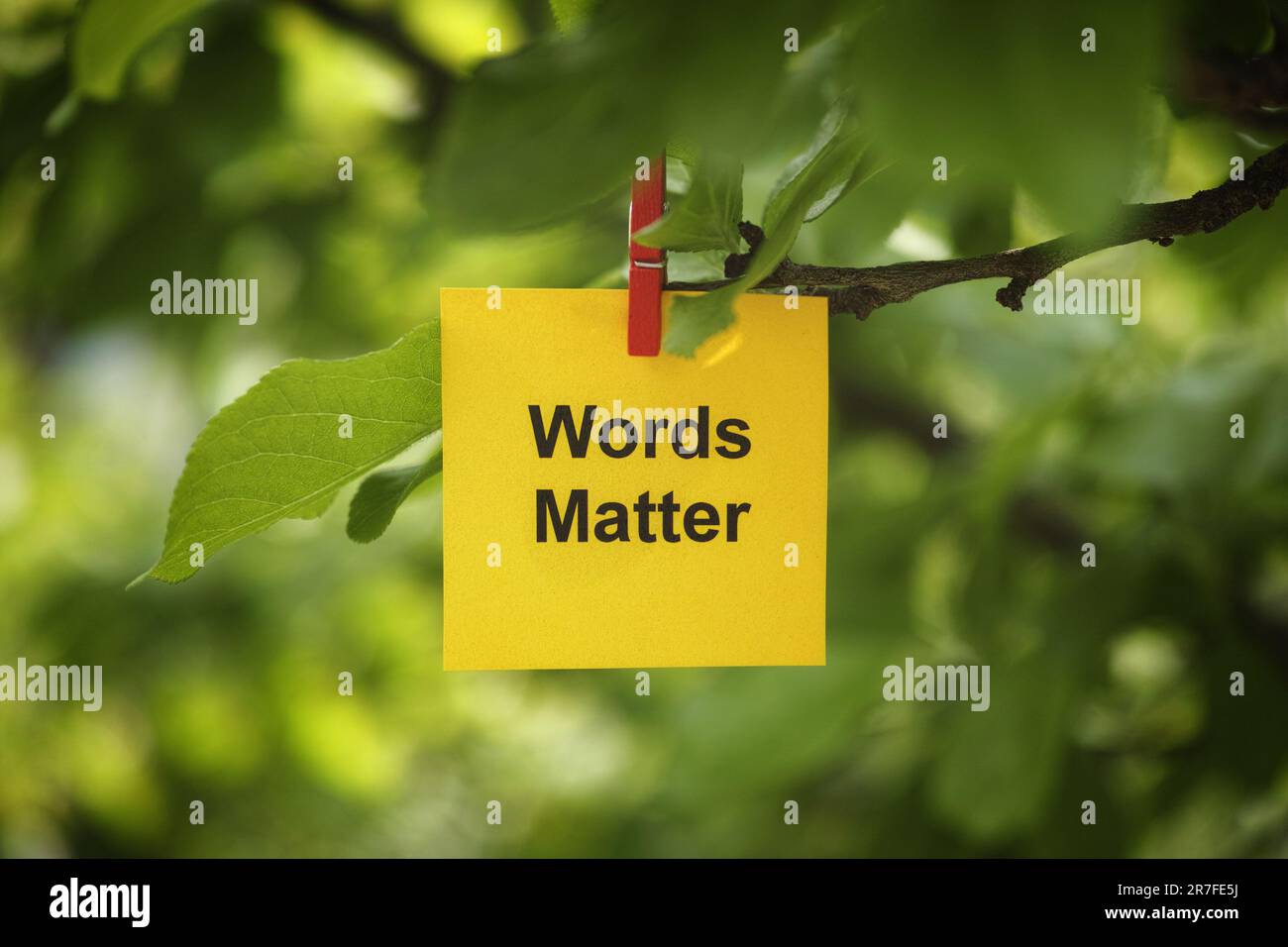 A yellow paper note with the phrase Words Matter on it attached to a ...