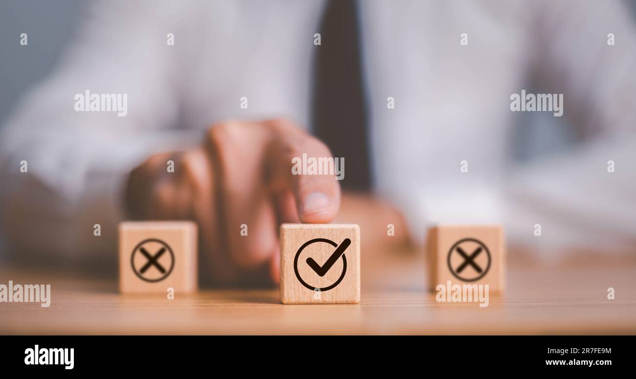 Checkmark and cross icons on wooden cubes on white background ...
