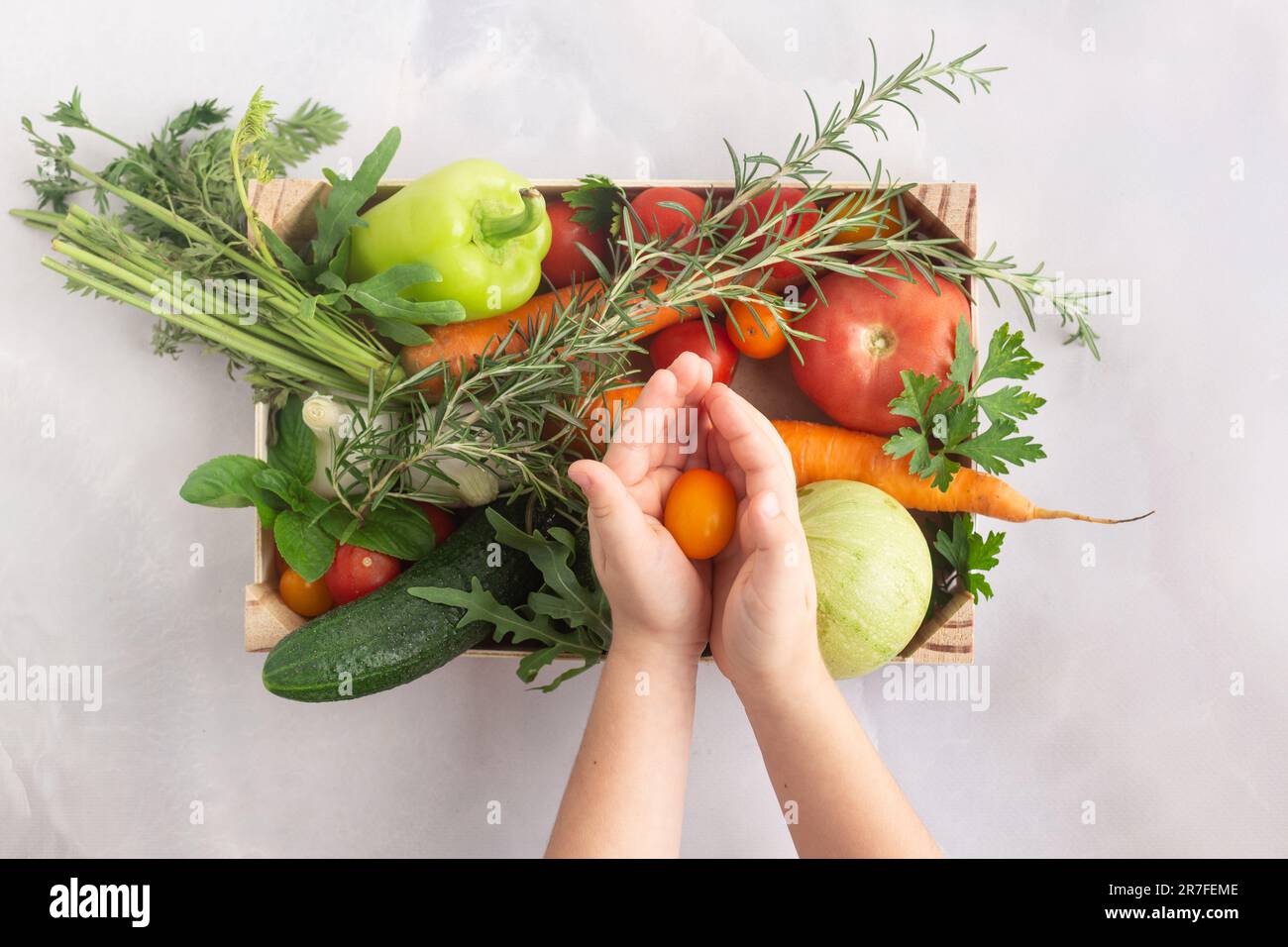 Organic farm vegetables in wooden box, vegetarian food concept child ...