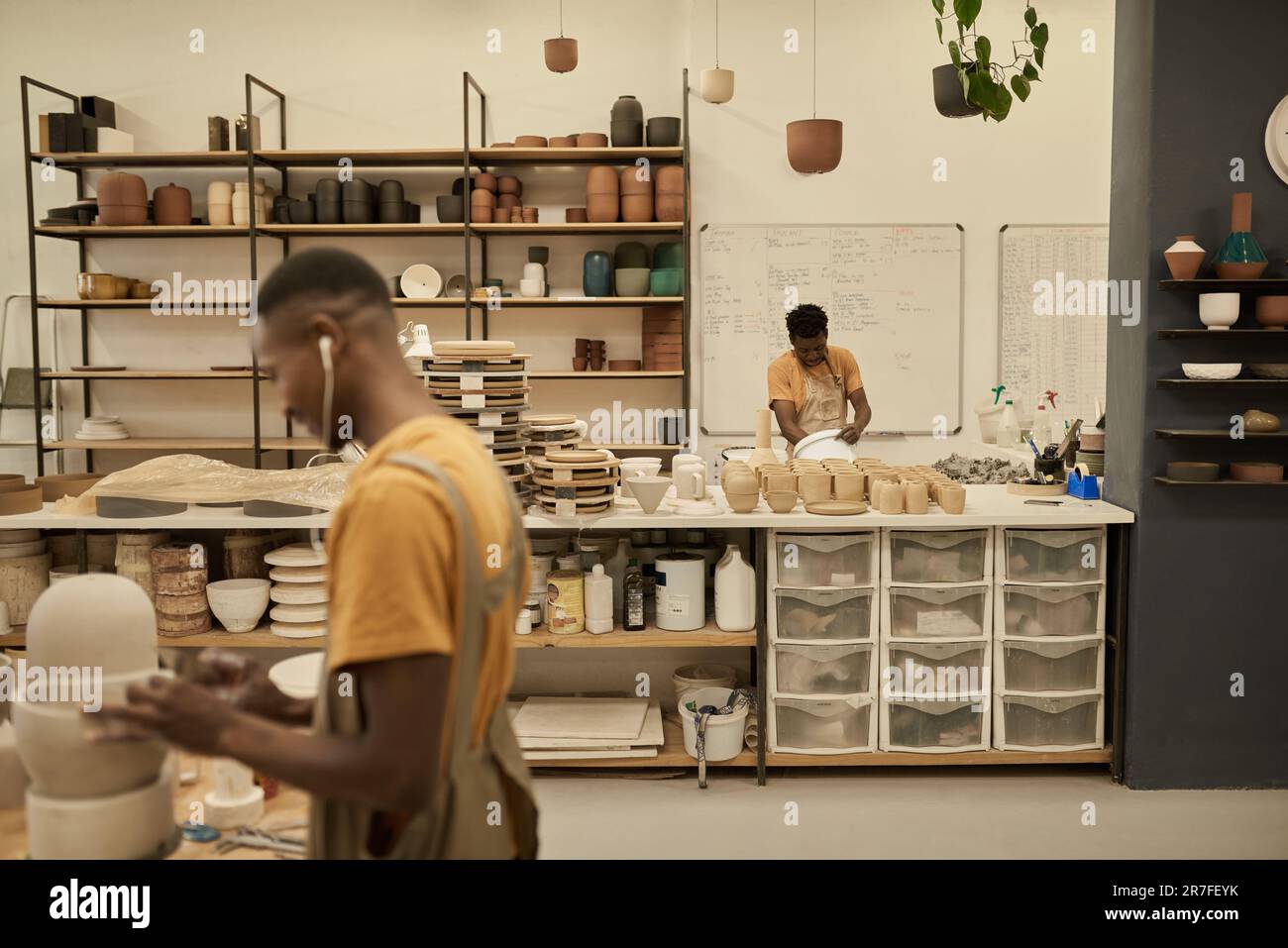 African potters working at benches in a large ceramics studio Stock ...