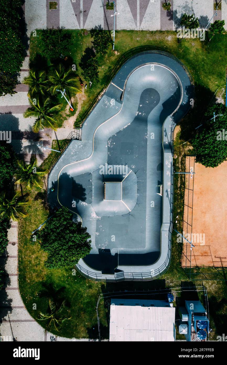 Aerial view of a vibrant skatepark situated in a lush park with verdant ...