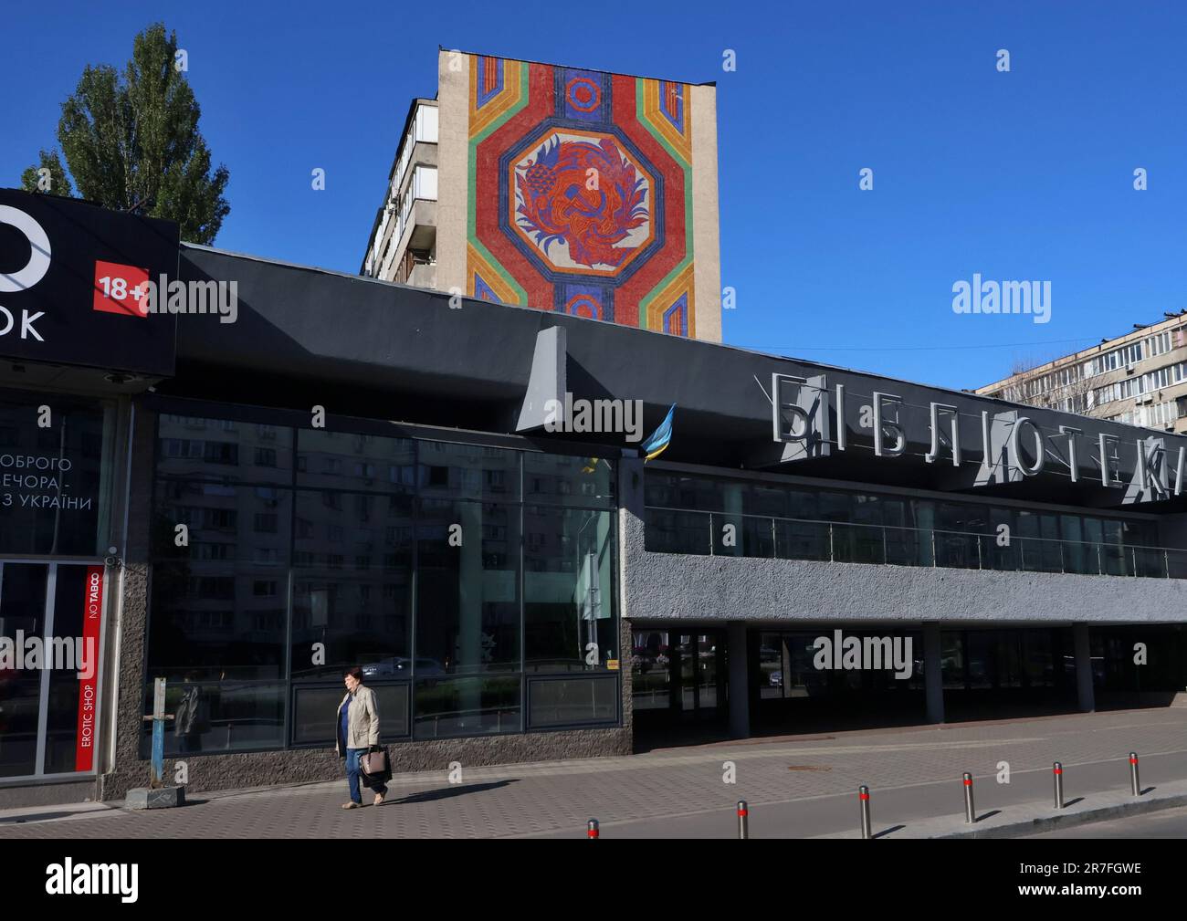People walk near the mosaic depicting the coat of arms of the Soviet ...
