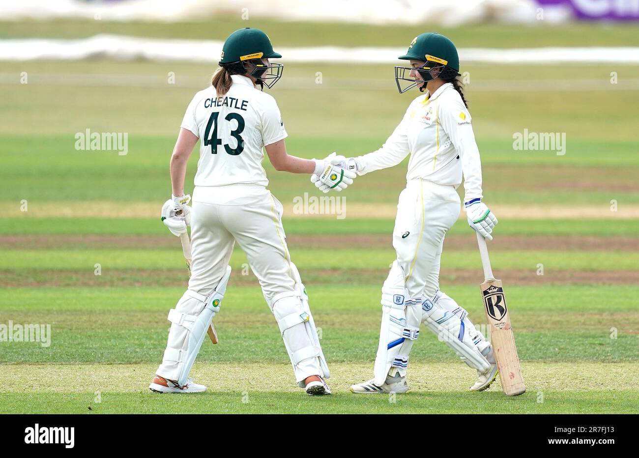 Australia's Charli Knott (right) celebrates reaching a half century ...