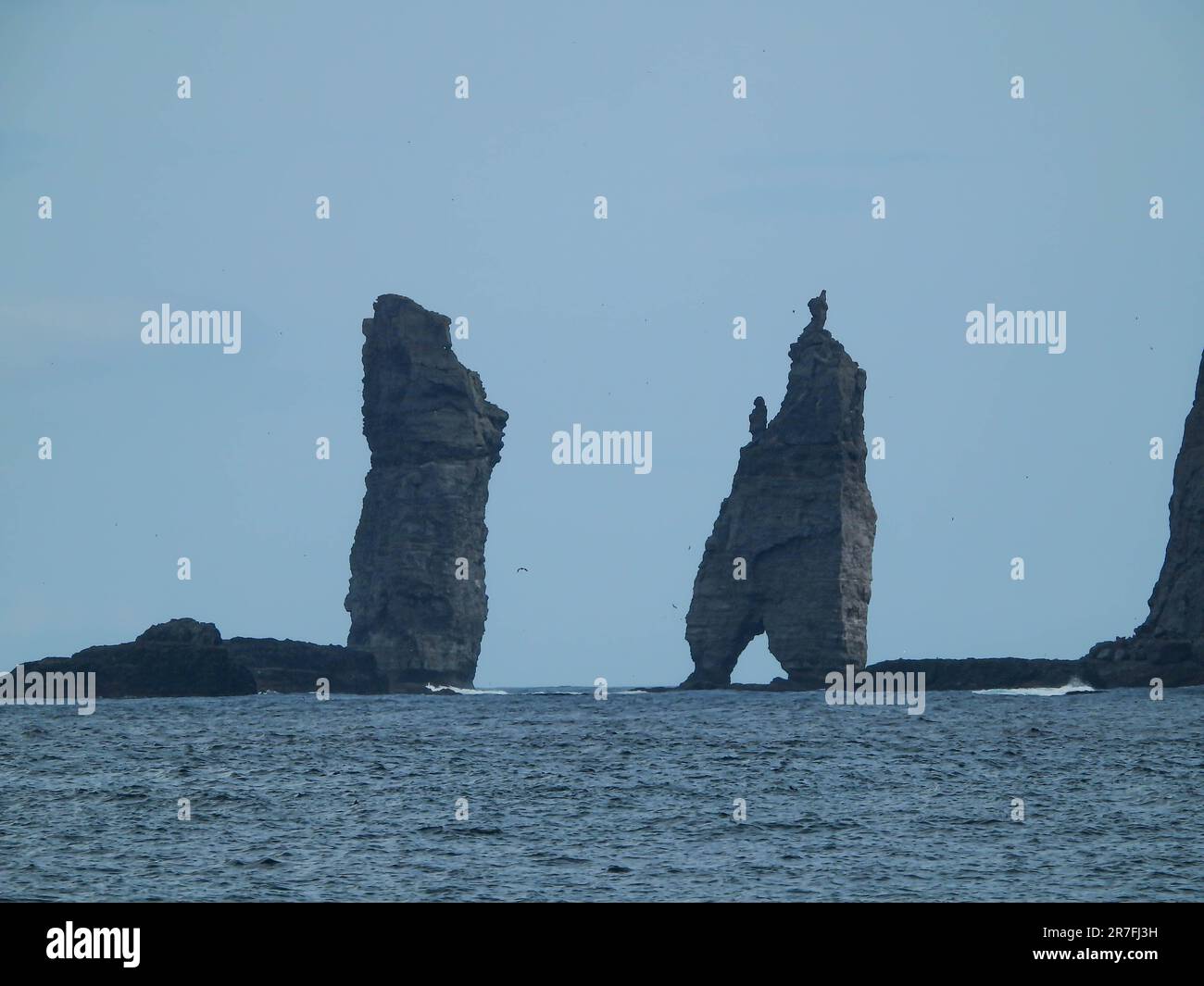 A breathtaking view of the iconic sea stacks Risin and Kellingin ...