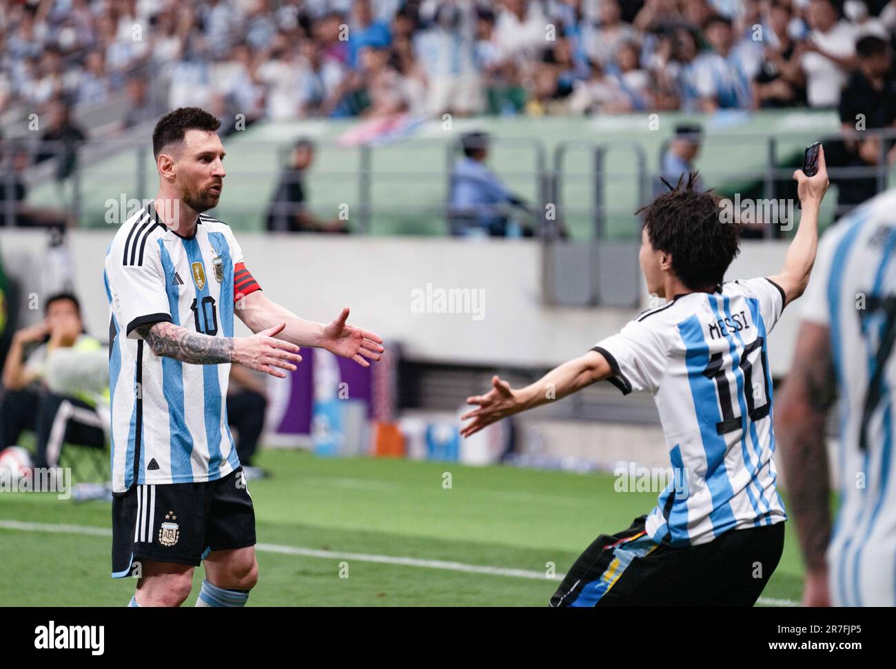 Beijing, China. 15th June, 2023. A pitch-invading fan (R) tries to hug ...