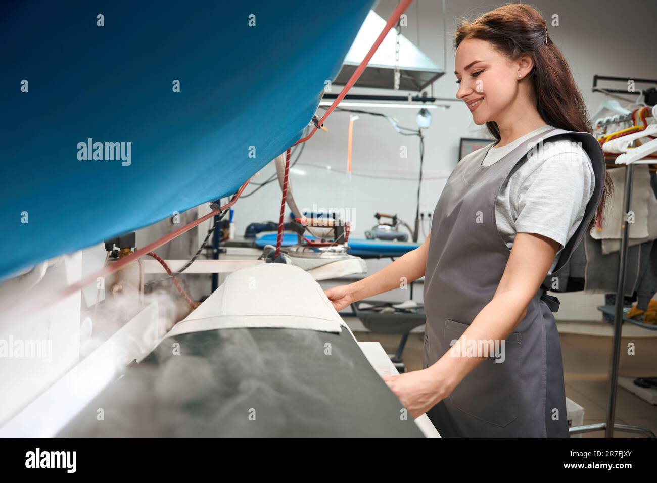 Close-up garment drying and ironing on steam press Stock Photo - Alamy