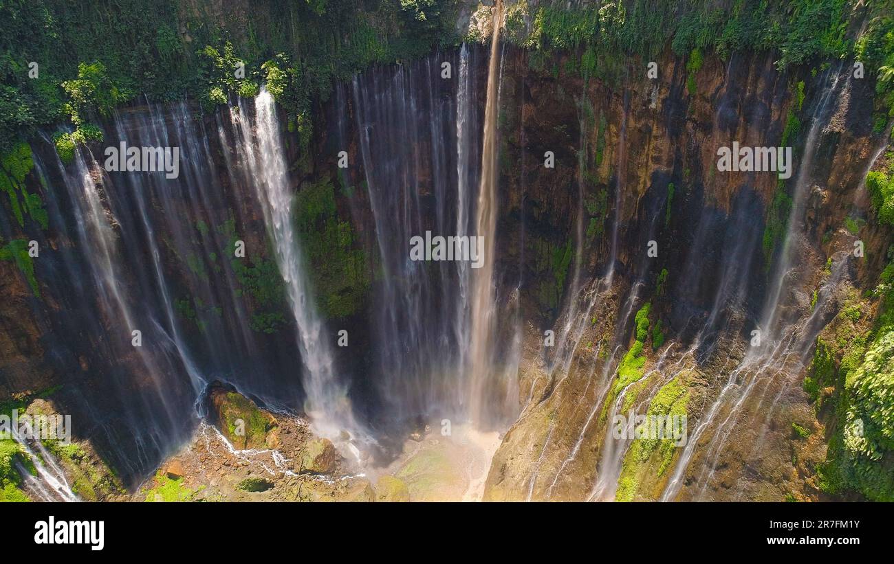 beautiful waterfall Coban Sewu in tropical forest, Java Indonesia ...